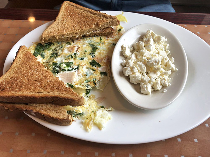 This isn't just an omelet—it's breakfast architecture. Egg whites folded around turkey and spinach with toast standing guard.