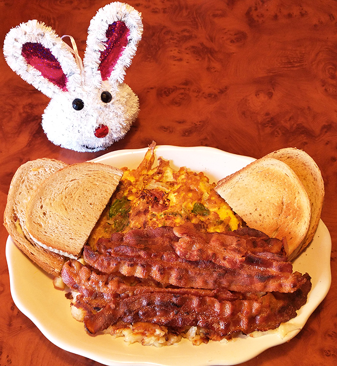 Easter breakfast done right – a veggie-packed omelet, perfectly crisped bacon, and toast standing by for yolk-sopping duty.