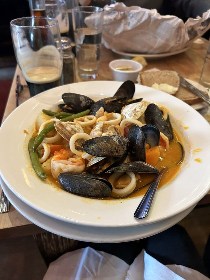 The seafood stew that launched a thousand return visits—a broth so rich it could buy real estate in Boston's Back Bay.