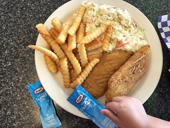 Coleslaw that actually deserves a place on your plate, alongside golden fish and those signature crinkle fries—a trio of simple perfection.