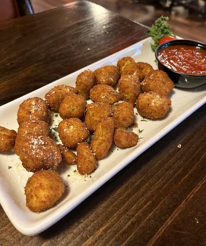 These golden-fried cheese curds don't squeak—they sing. Crispy outside, molten Wisconsin cheese inside, with marinara standing by for the perfect dunk.