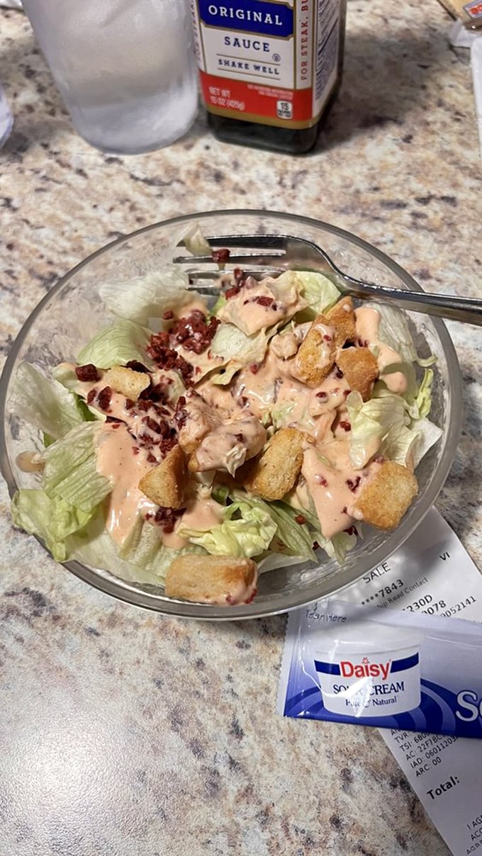 A simple side salad elevated by thousand island dressing and bacon bits – proving that even the supporting players deserve their moment in the spotlight.