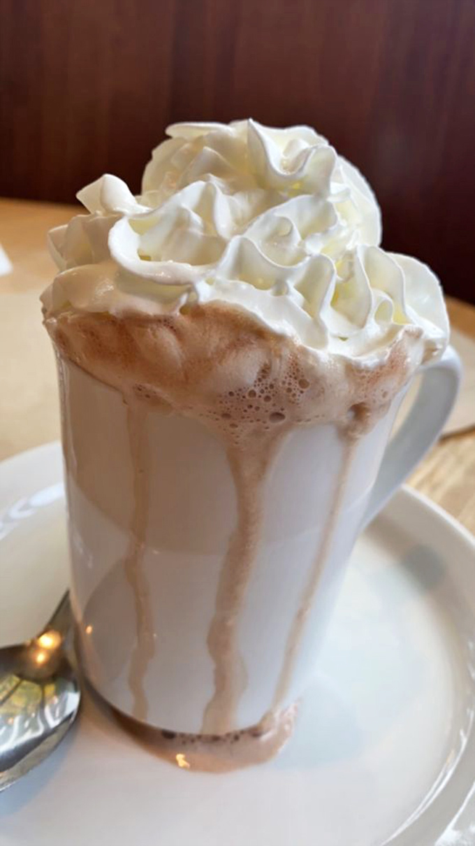 Hot chocolate that's dressed for a special occasion, with whipped cream piled higher than Portland winter clouds.