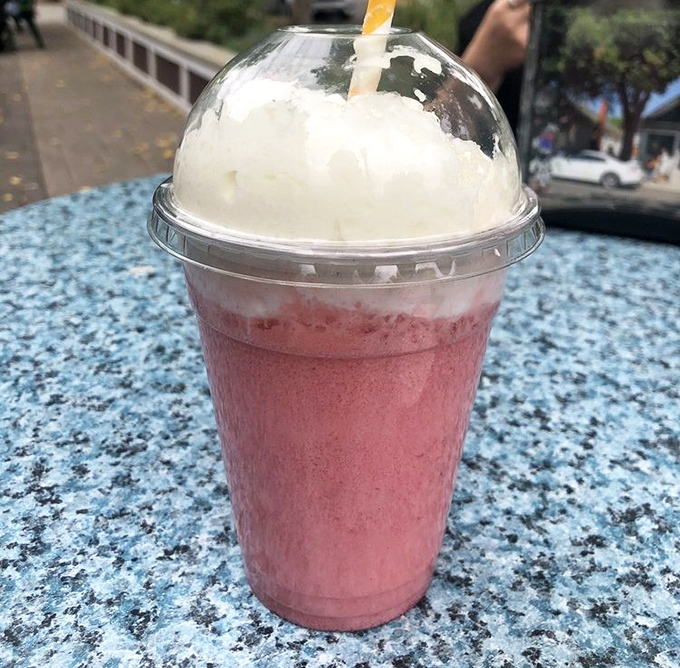 This isn't just a strawberry Italian soda—it's summer in a cup, complete with that dome lid holding back an avalanche of joy.