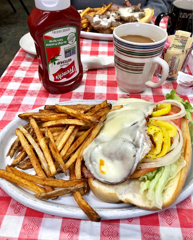 A sandwich so loaded with goodness it requires strategic planning to eat—the kind of meal that demands both hands and your complete attention.