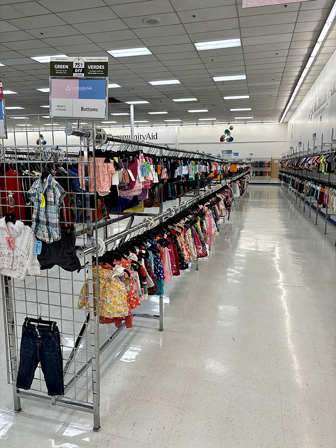 Color-coded clothing racks create a rainbow road of fashion possibilities. The "green tag" sale adds another layer of thrill.