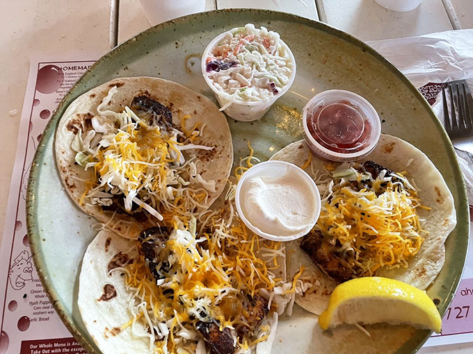 These fish tacos aren't just a meal, they're a fiesta on a plate – blackened mahi-mahi topped with melted cheese and fresh cabbage.