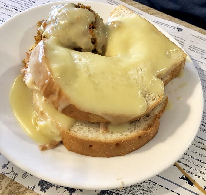 Hot turkey sandwich smothered in gravy so good you'll want to write poetry about it—comfort food that speaks the universal language of "mmmmm."