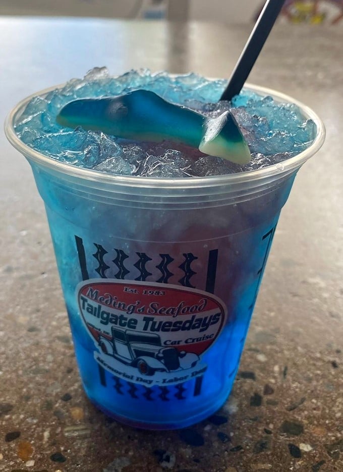 Electric blue meets shark-shaped garnish. This drink doesn't just refresh—it tells a story of ocean depths and summer celebrations.