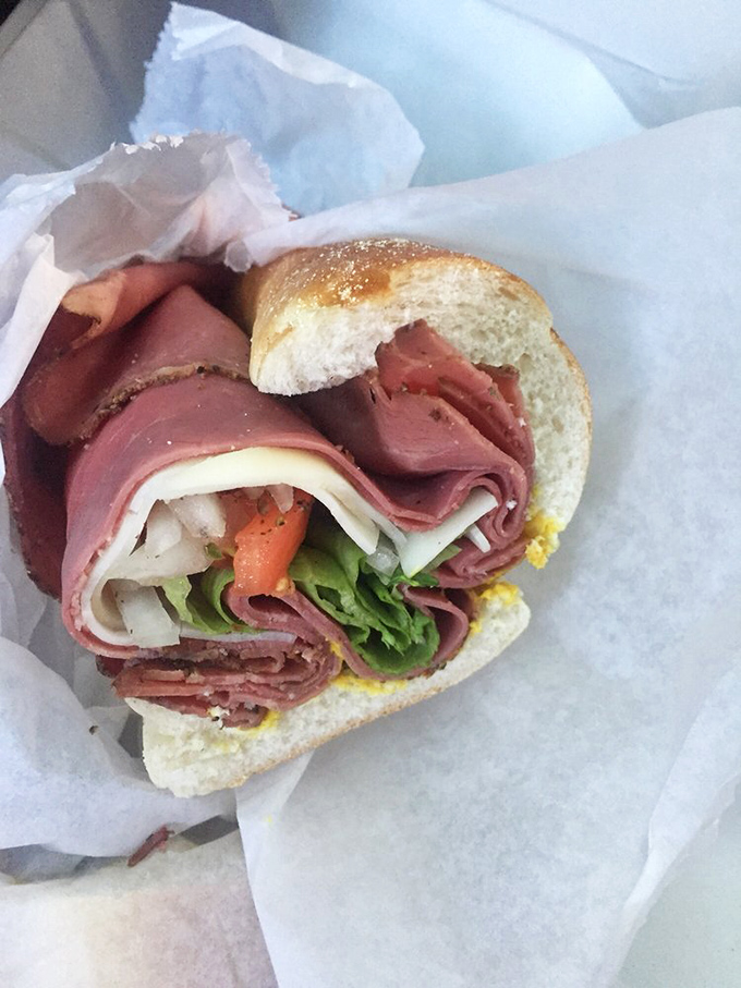 Pastrami poetry on fresh bread – each slice telling a smoky, peppery story that makes your taste buds stand up and applaud.