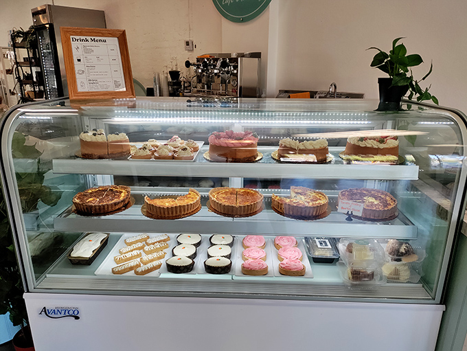 The display case—a glass-fronted museum of pastry perfection—showcases tarts, cakes, and other treats that make choosing just one nearly impossible.