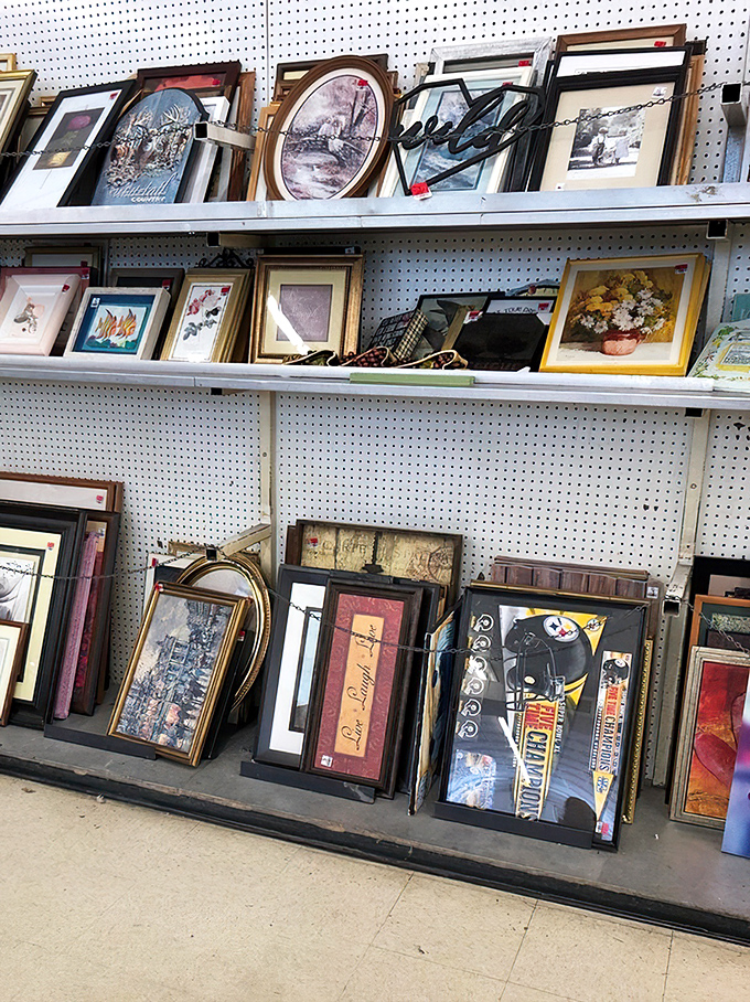 Wall art waiting for its second act—from Steelers memorabilia to pastoral scenes that once graced Grandma's dining room.
