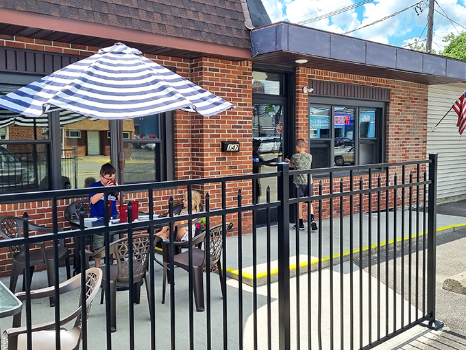 Outdoor dining under striped umbrellas – where conversations flow as freely as the beverages and nobody's checking their watch.