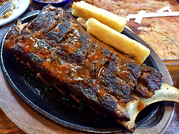 These ribs don't just fall off the bone—they practically leap into your mouth, bringing along yucca fries as willing accomplices to deliciousness.