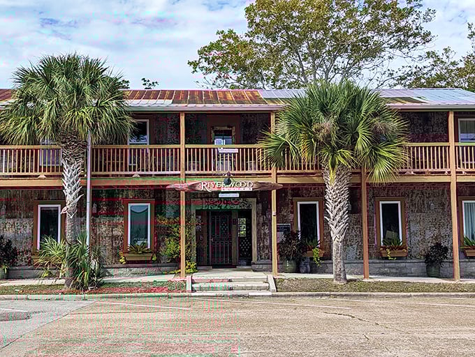 The weathered facade of Riverwood Suites tells stories of Gulf hurricanes and salty air, while offering shelter just steps from the waterfront.