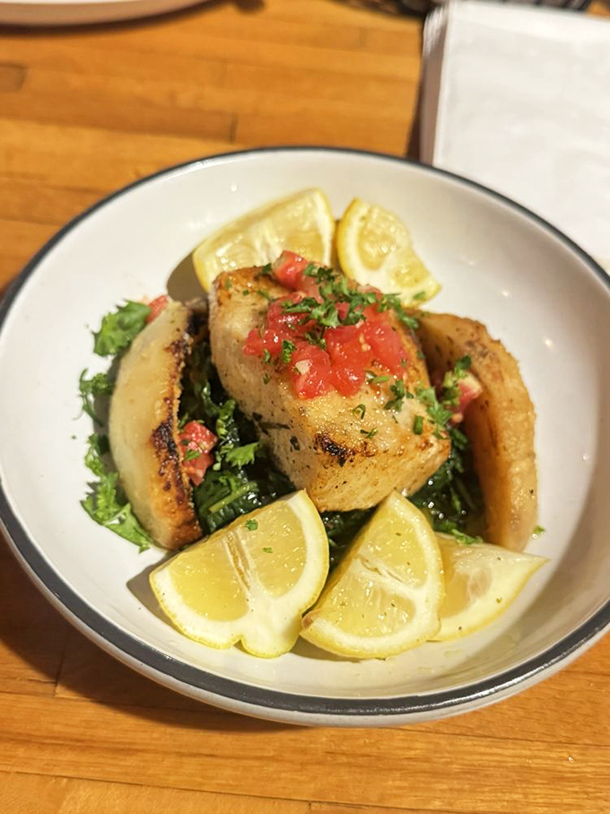 Sea bass deserves this kind of treatment – simply prepared but profoundly delicious. Those lemon wedges aren't just garnish, they're supporting actors.