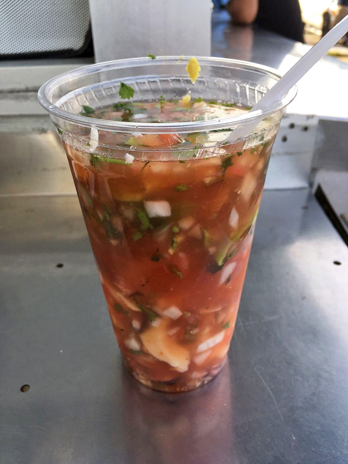 This seafood cocktail holds more treasures than a pirate's chest—tomato-based broth swimming with ocean jewels and cilantro confetti.