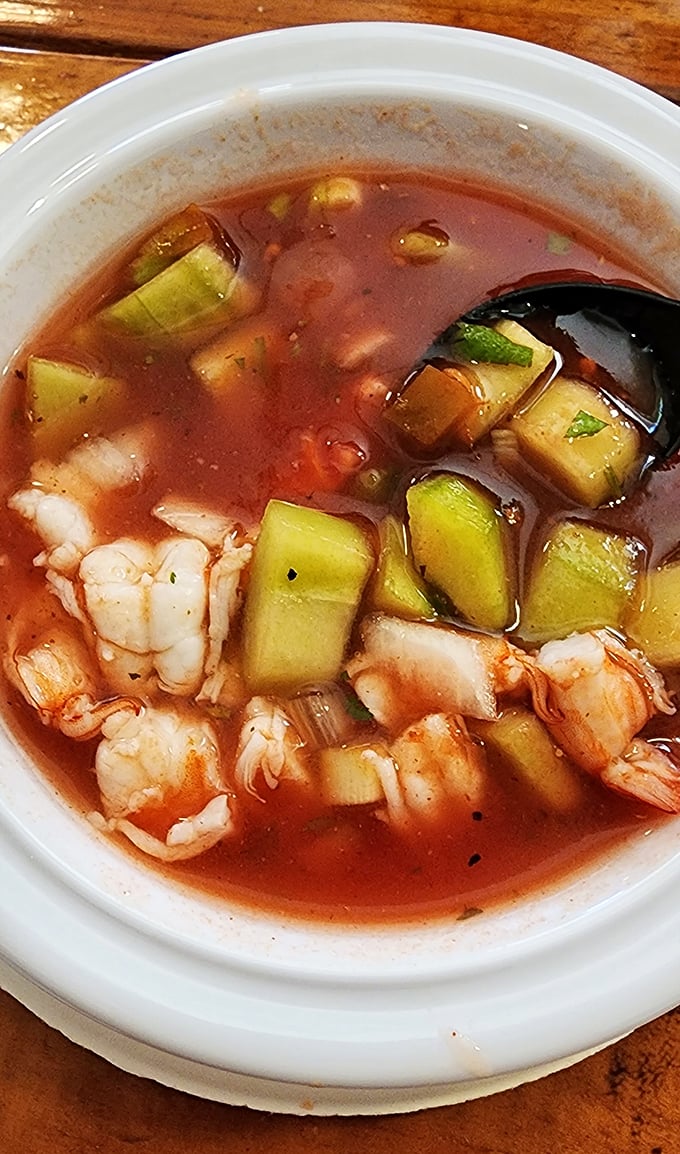 A proper shrimp cocktail swimming in zesty broth with cucumber—like a refreshing pool party where everyone's invited.