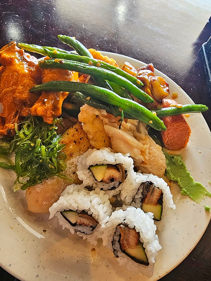 A plate that tells the story of culinary wanderlust – where sushi, green beans, and various Asian-inspired dishes coexist in delicious harmony.