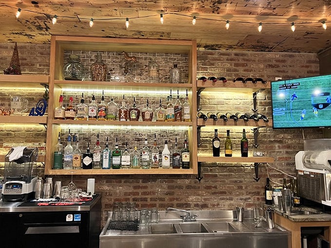 The bar area showcases an impressive array of spirits against exposed brick—where decisions about bourbon are taken as seriously as football.