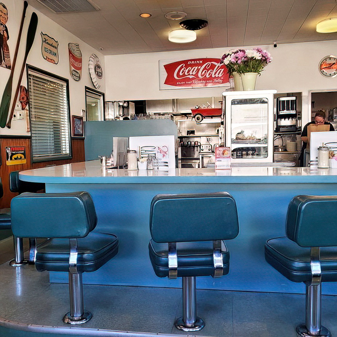Classic blue counter stools and vintage Coca-Cola signs—time travel is possible, and it comes with coffee refills.