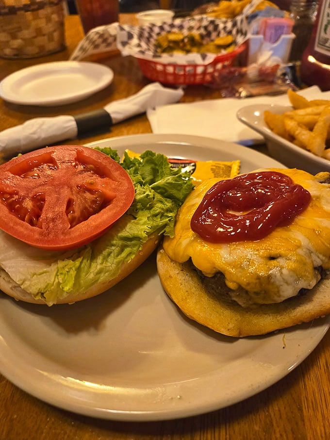 This isn't some fancy gastropub's "deconstructed" burger experiment. It's the real deal—cheese melting just right, tomato slice the size of a small frisbee. 