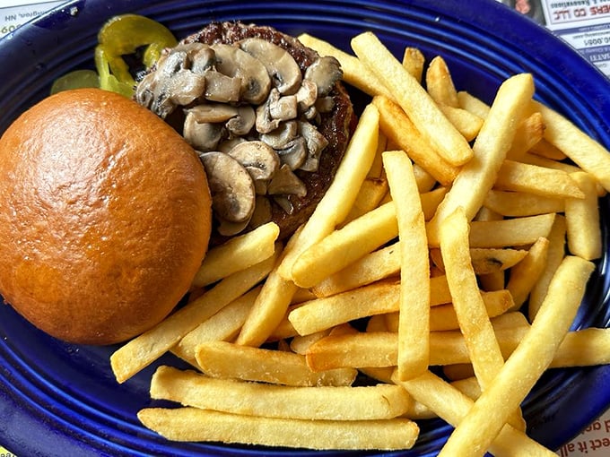 A burger and fries that doesn't need filters or fancy descriptions—just your full attention and maybe an extra napkin or two.