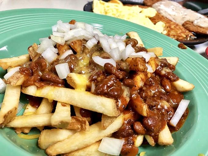 Chili fries that don't apologize for being exactly what they are—a glorious mess of savory, cheesy, oniony perfection worth every napkin.