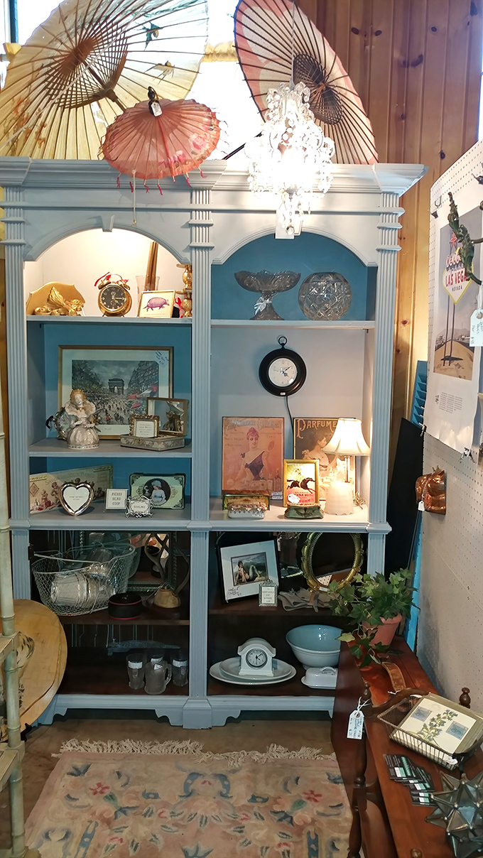 This dreamy blue cabinet display, complete with parasols and porcelain, creates a perfect vignette of elegance from another era.