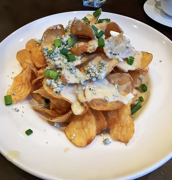 House-made potato chips drowning in blue cheese and scallions – proof that sometimes the simplest pleasures are the most profound.
