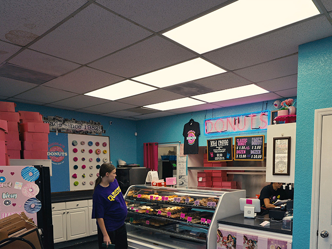 The donut counter experience—where anticipation and neon lighting create the perfect atmosphere for life-changing pastry decisions.