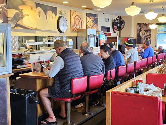 The counter crew—breakfast's front-row seats where regulars gather like old friends at a reunion of the "Early Birds Club."