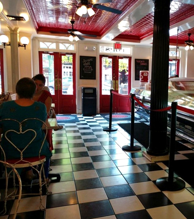 Even the seating has vintage charm—ice cream simply tastes better when enjoyed beneath that magnificent pressed tin ceiling.