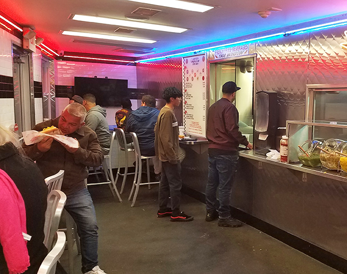 The lunch rush ballet—customers lined up, hunched over counters, lost in the meditative act of serious sandwich consumption. A beautiful Philadelphia ritual.
