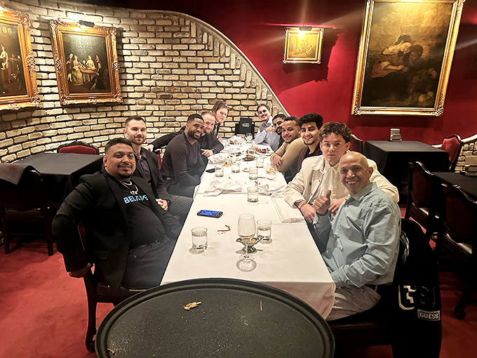 Great meals create great memories. This gathering of friends around a white tablecloth represents what dining out is truly about—connection and celebration.