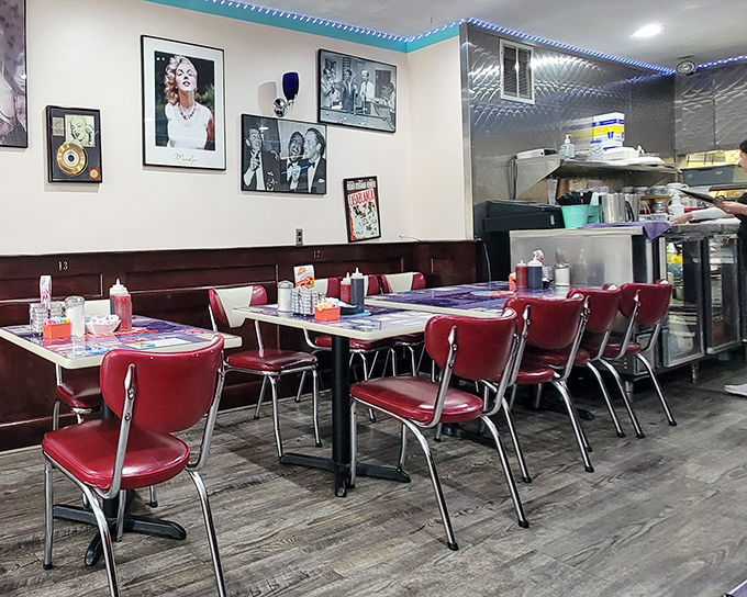 Marilyn Monroe and Elvis watch over diners from their wall perches. The red chairs aren't just seating—they're front-row tickets to the greatest show on earth: breakfast in America.