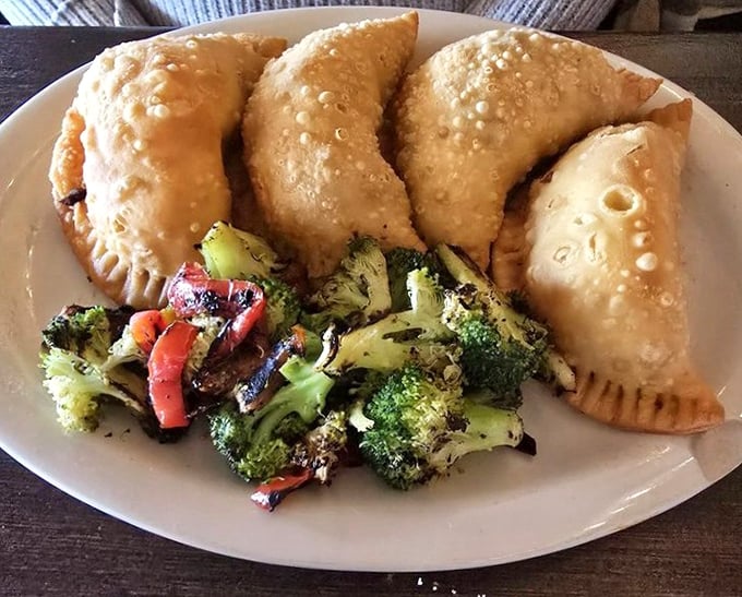Empanadas with a side of vegetables – because balance is important when you're about to order three margaritas and flan.