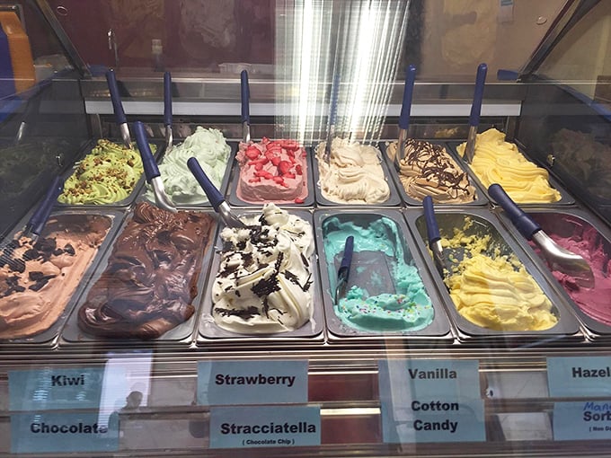 Gelato flavors lined up like edible paint swatches—from cotton candy blue to strawberry pink, each promising brain freeze worth experiencing.