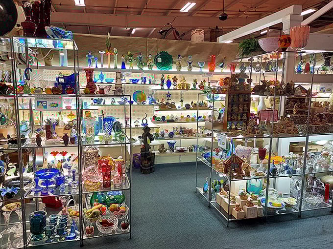 A kaleidoscope of vintage glassware catches the light—each shelf a rainbow of colors that grandmother would recognize but rarely used.