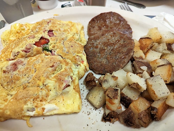 When an omelet meets a sausage patty, magic happens – especially when both are cooked on a well-seasoned flat-top that's seen decades of breakfast service.