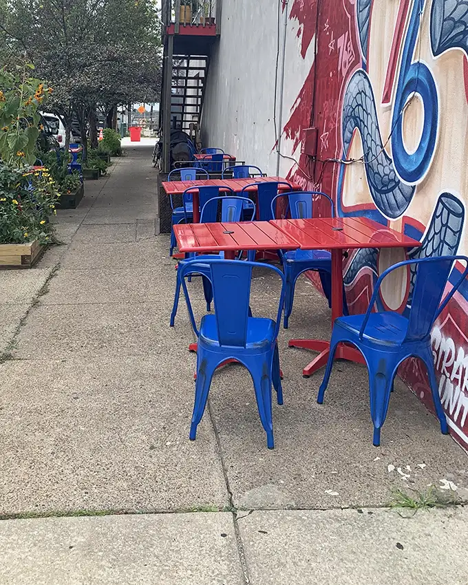Outdoor seating with Philly attitude. Those blue chairs have seen things—mostly happy people enjoying post-breakfast conversations.
