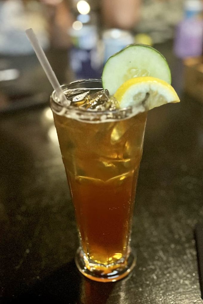 A Pimm's Cup garnished with cucumber and lemon—summer in a glass. The unofficial drink of Wimbledon finds a happy home in Nashville.