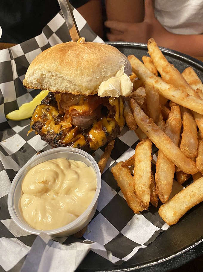 When a burger requires structural engineering and comes with its own support system of golden fries, you know you're in for something special.