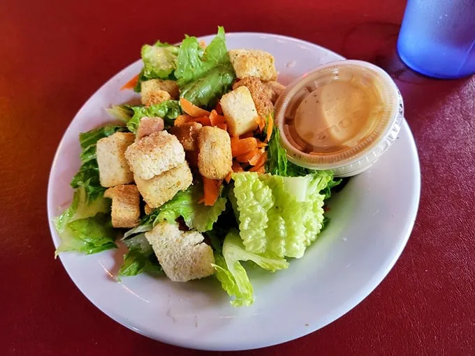 Even the salad gets respect here—crisp greens, crunchy croutons, and a dressing that doesn't apologize for being delicious. Balance, people. Balance.