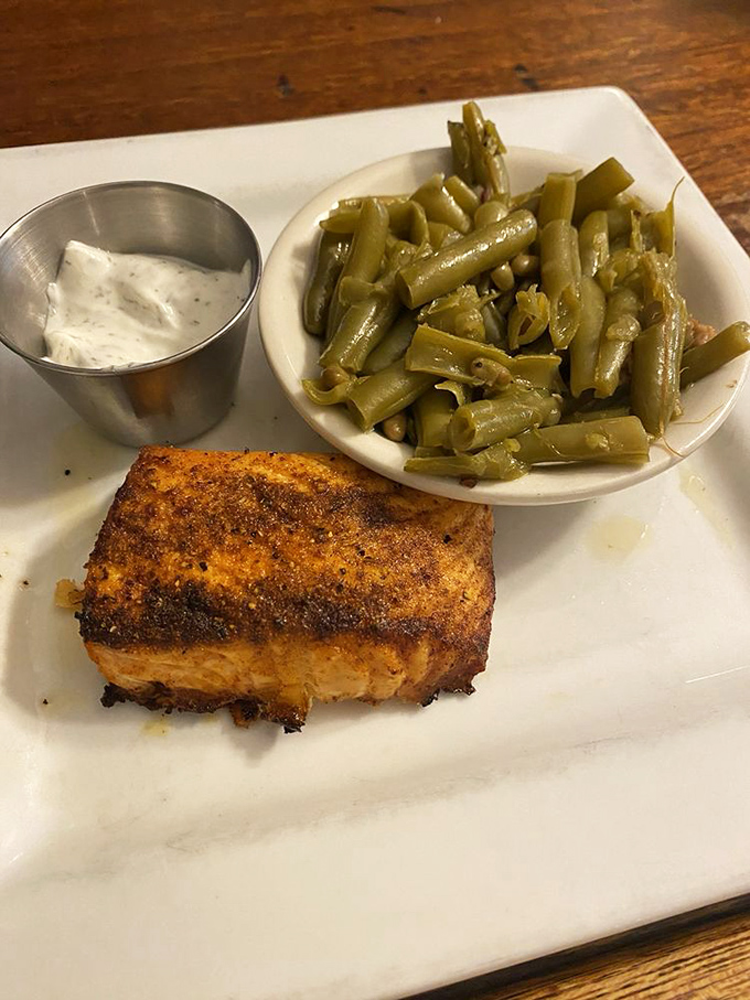 Perfectly seared salmon with a golden crust alongside green beans that haven't been tortured into submission—simple food done right is revolutionary these days.