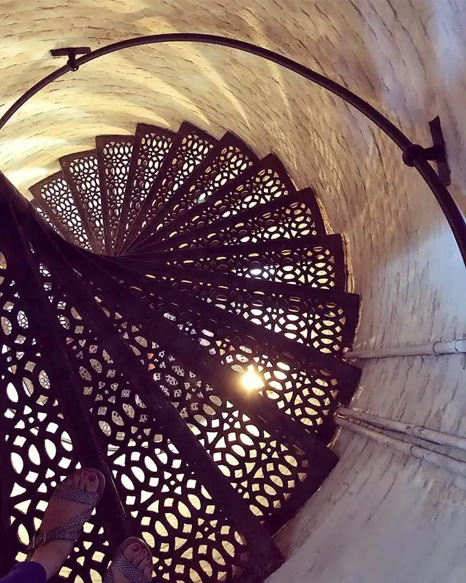 These ornate iron spiral stairs aren't just functional—they're Victorian industrial art that would make steampunk enthusiasts weak at the knees.