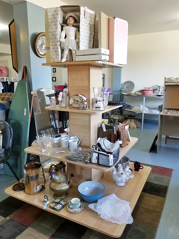 This multi-tiered display showcases everything from vintage glassware to collectible dolls—each shelf a different chapter in someone's story.