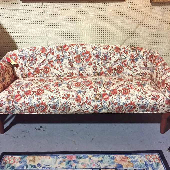 This floral couch isn't just furniture—it's a statement piece that screams "your grandma's formal living room where no one was allowed to sit."