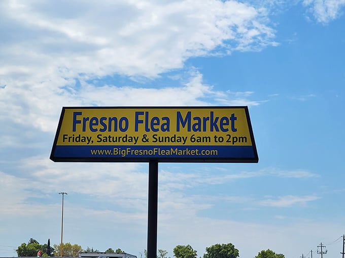 The Fresno Flea Market sign against blue Central Valley skies—a beacon of bargains in California's heartland.