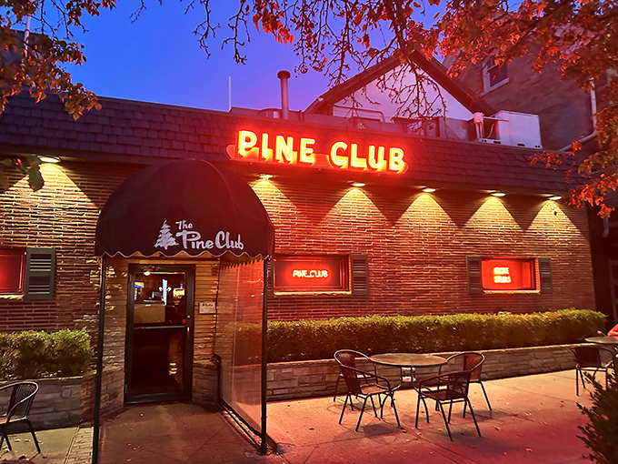 The Pine Club's neon sign glows like a red-hot beacon in the night, guiding steak pilgrims to their delicious destination.